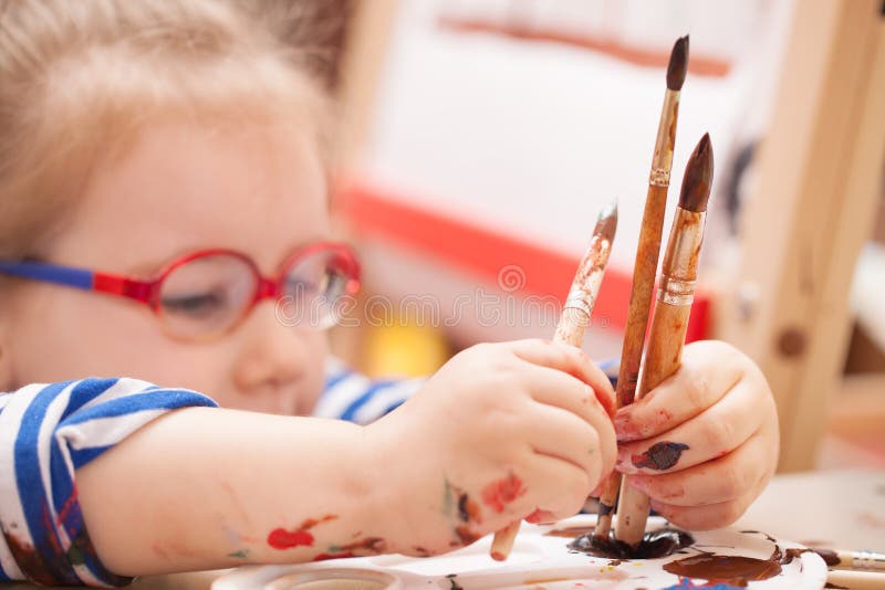 Girl Considering a Brush and Paint Stock Image - Image of artist, child ...