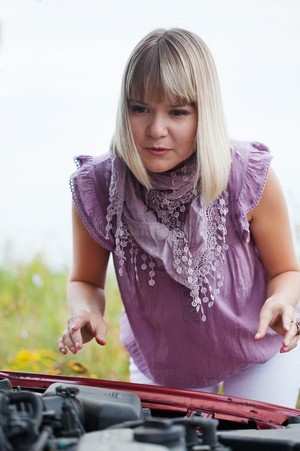 Girl considers the engine stock image. Image of repair - 21328967
