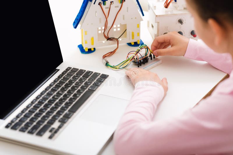 Girl Constructing Robot and Programming it on Laptop Stock Photo ...