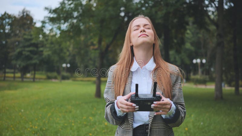 The Girl Controls the Drone with the Remote Control in Her Hands. Stock ...