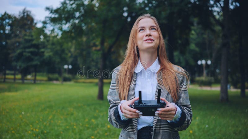 The Girl Controls the Drone with the Remote Control in Her Hands. Stock ...