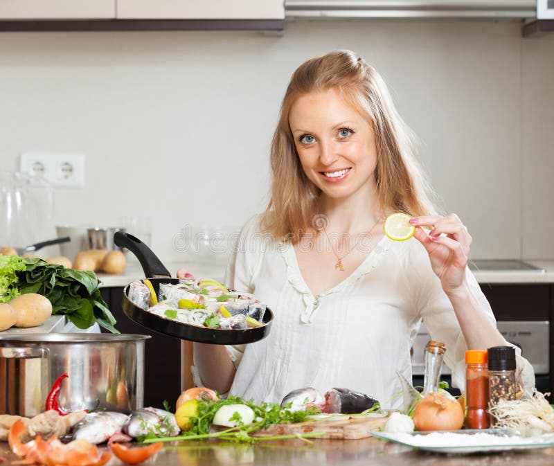 Girl Cooking Fish with Lemon at Kitchen Stock Photo - Image of food ...
