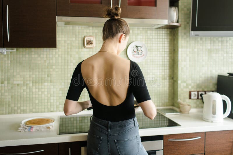 The Woman is Cooking in the Kitchen, the Back View Stock Photo - Image ...