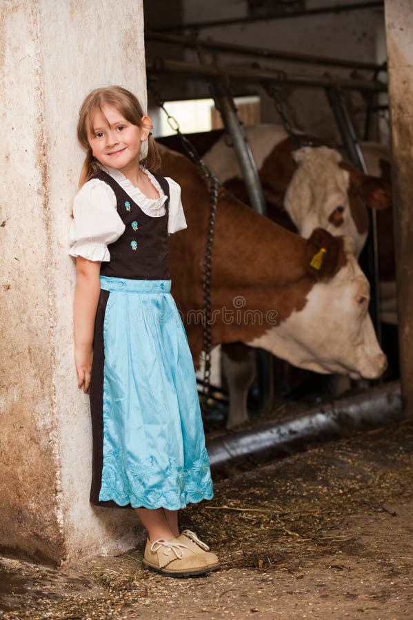 Girl in a cow stable stock photo. Image of farming, smile - 31635936