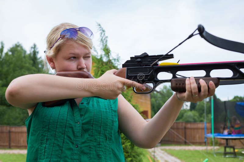 A Girl with a Crossbow Aiming at a Target Stock Image - Image of face ...