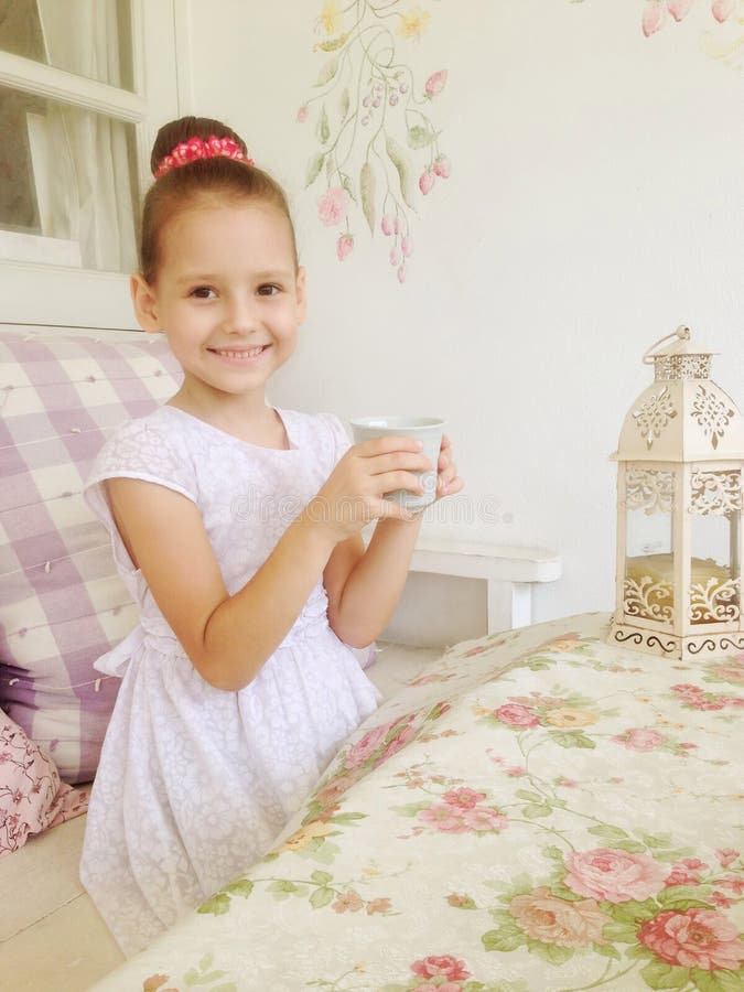 Girl with cup at the table stock image. Image of floor - 56031817