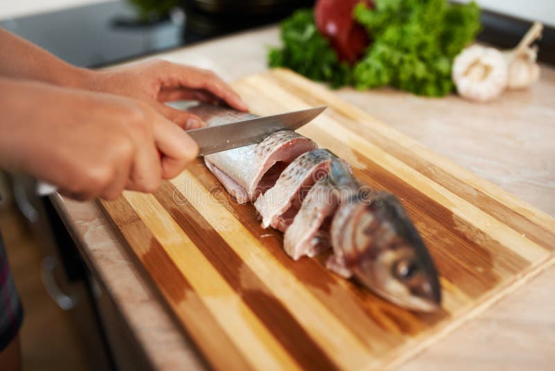 Girl cut slice of fish stock photo. Image of garlic, indoor - 60680150
