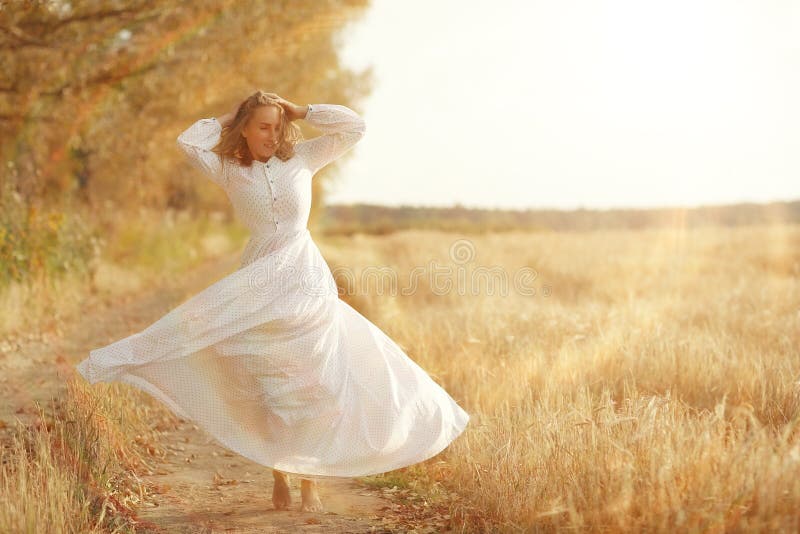 Girl Dancing in Field in White Dress Stock Photo - Image of grass ...