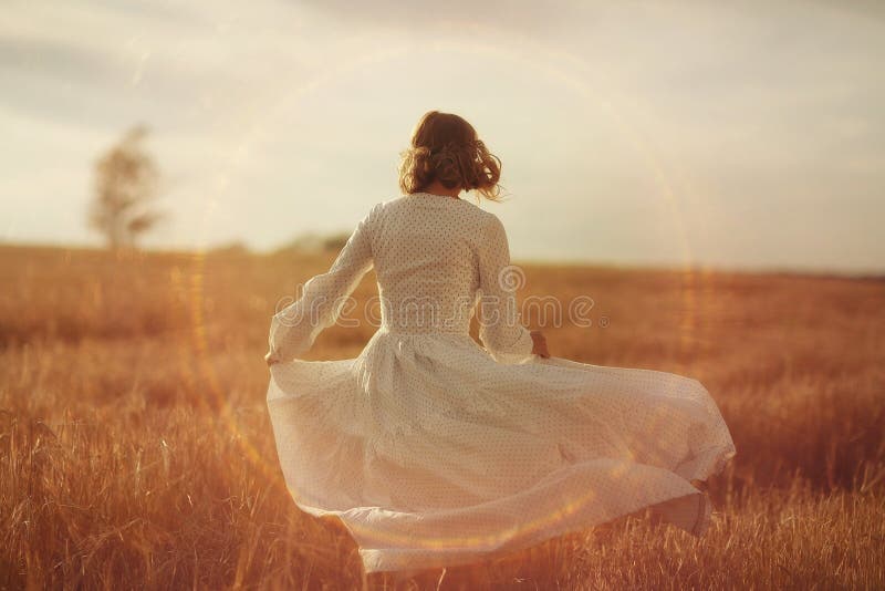 Girl Dancing in Field in White Dress Stock Image - Image of field ...