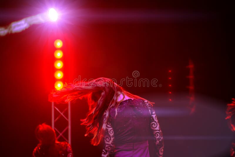 Girl Dancing on Stage in the Rays of Red Light. Soft Focus Editorial ...