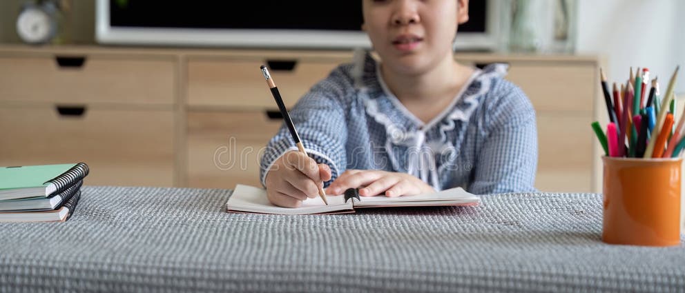 Focused Learning and Writing. a Teenage Girl with Down Syndrome Writing ...