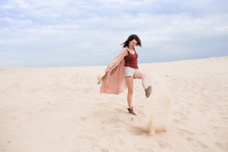 Girl in Desert Walk and Spills Sand with Hat and Boots Stock Photo ...