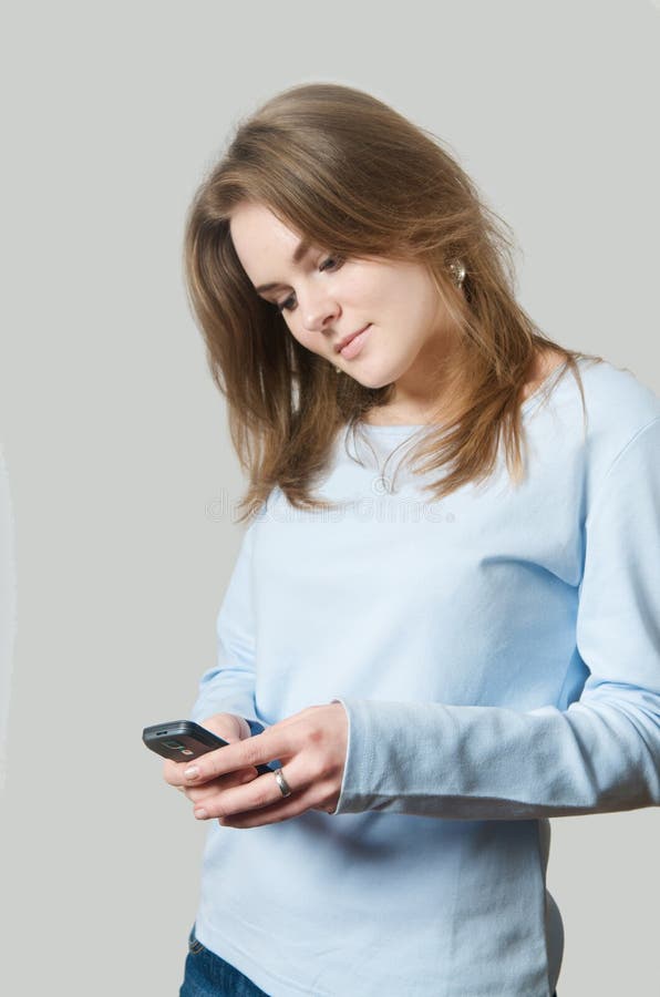 Girl dialing on cell phone stock image. Image of blue - 13452383