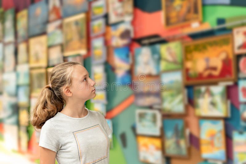 A Girl on Display at an Art Gallery Looks at Fine Art Stock Image ...