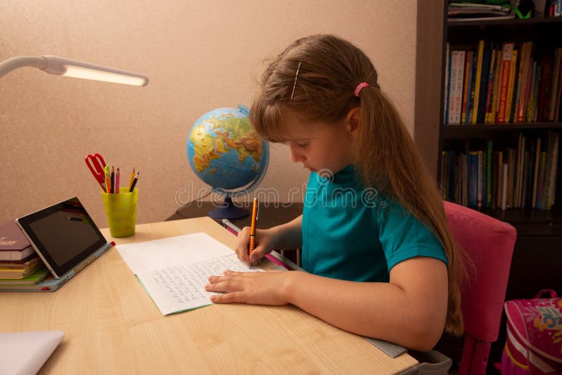 A Girl Does a Home Remote Task, Homework in the Evening Stock Image ...