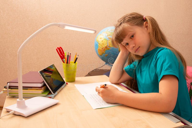 A Girl Does a Home Remote Task, Homework in the Evening Stock Image ...