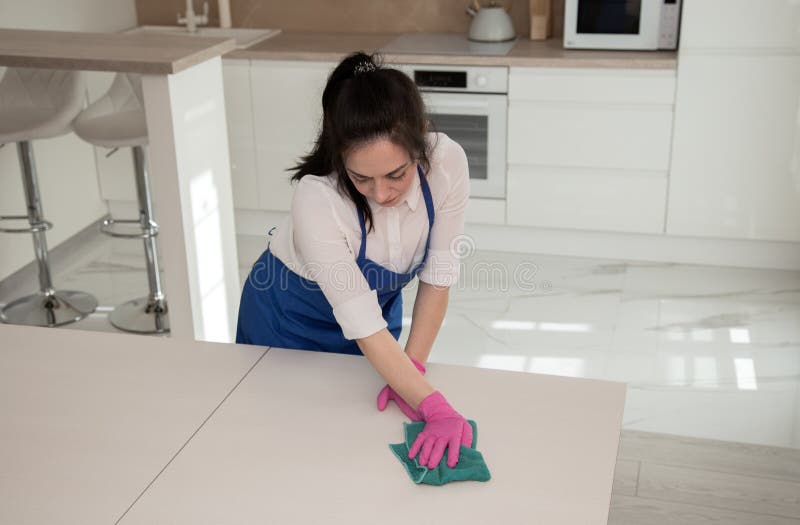 The Girl Does a Thorough Cleaning in the Kitchen. it Wipes a White ...
