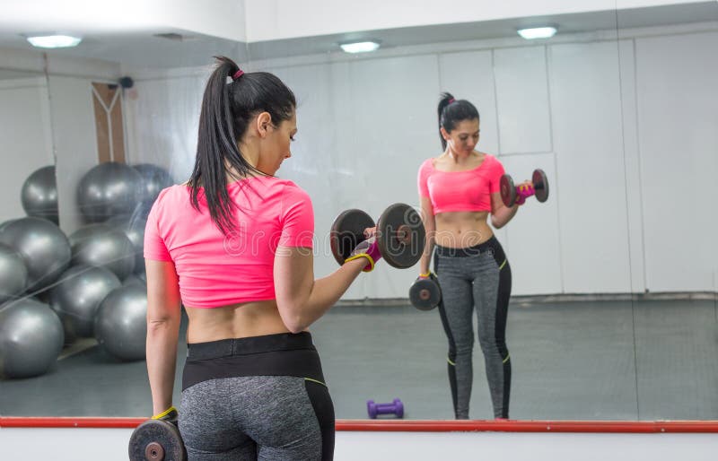 Girl doing biceps workout stock image. Image of girl - 68862061