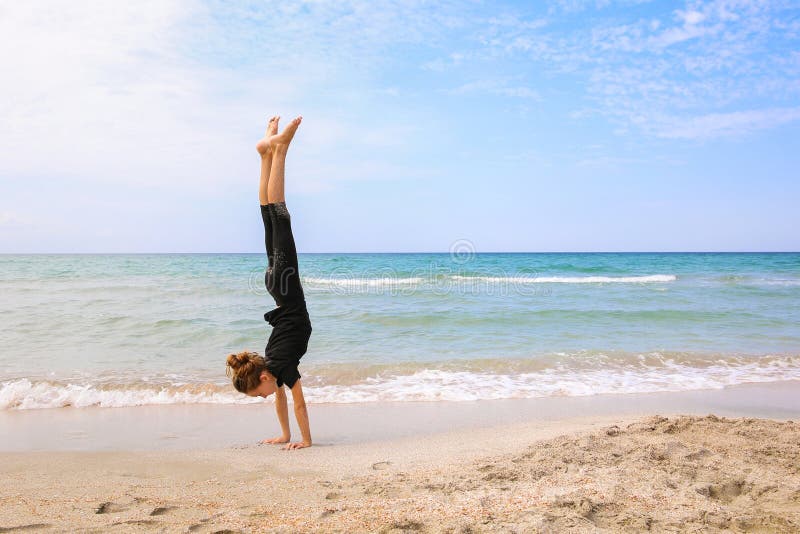 Girl Doing Gymnastics on Beach Stock Photo - Image of outdoor, physical ...