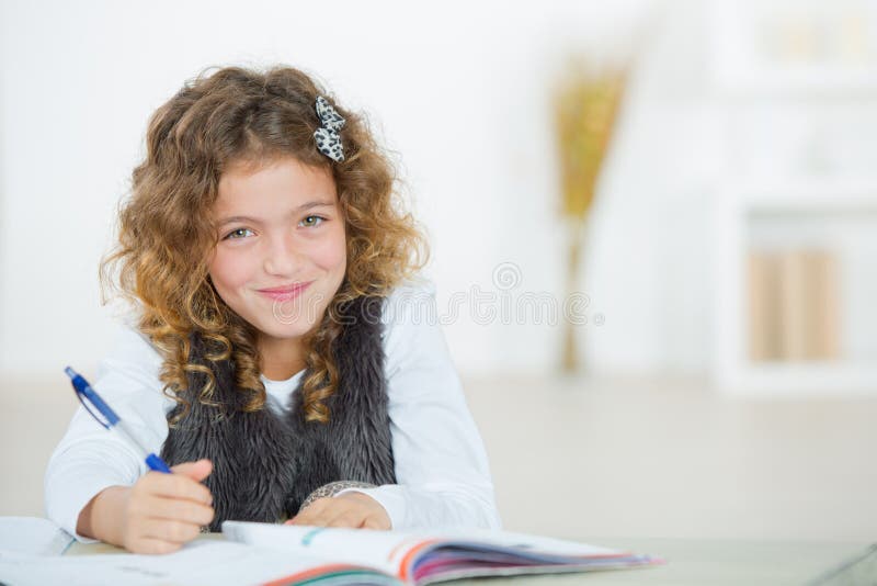Girl doing her homework stock photo. Image of interest - 124187132