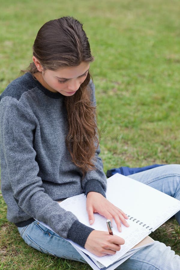 Girl Doing Her Homework while Sitting on the Grass Stock Image - Image ...