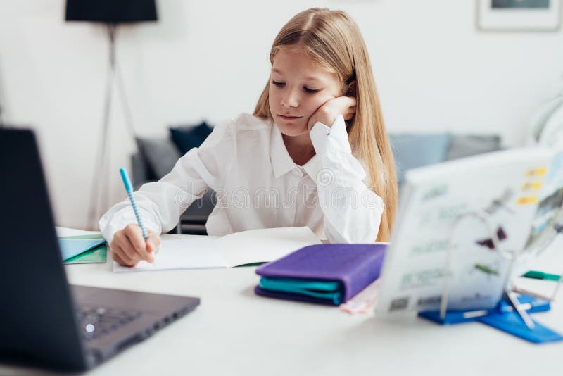 Girl is Doing Her Homework, Writing in Her Notebook. Stock Photo ...