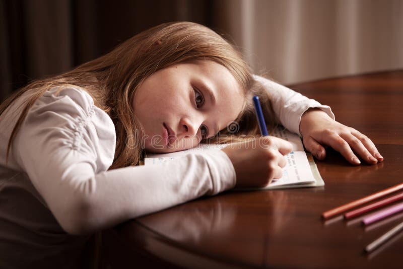 Sad girl doing homework stock image. Image of school - 34383011