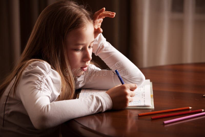 Sad girl doing homework stock image. Image of school - 34383011