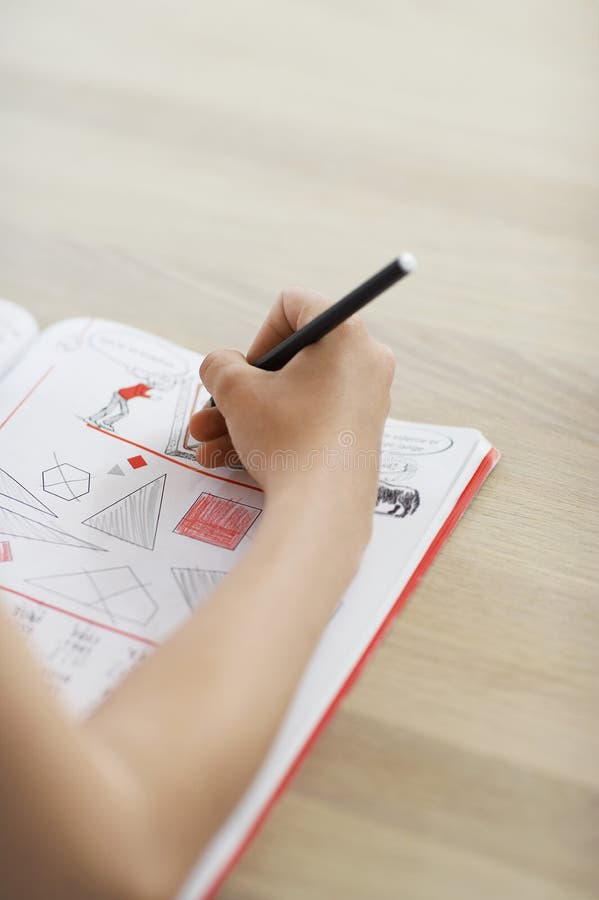 Girl Doing Homework on Table Stock Image - Image of desk, hand: 31834169