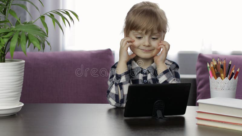Girl Doing Lessons at Home Using Digital Tablet Computer. Distance ...