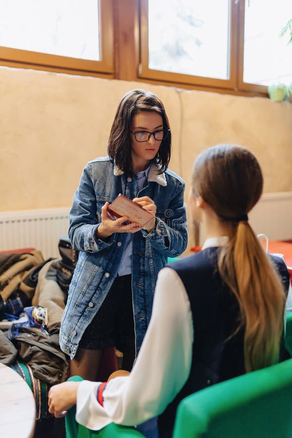 Girl doing make up in cafe stock photo. Image of glamour - 143843238