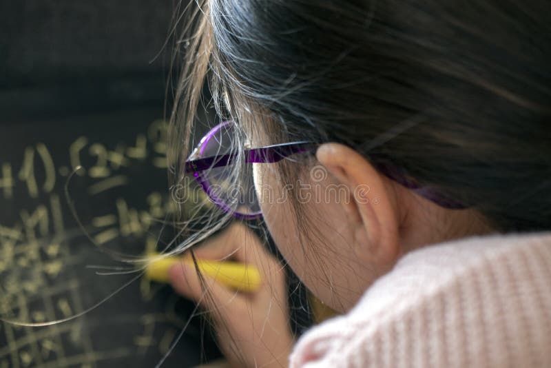 Girl Doing Math with Chalk on Blackboard. Stock Photo - Image of ...
