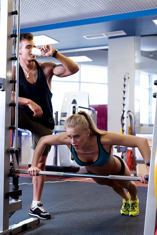 Girl Doing Push-ups and Her Trainer Drinking Water Stock Photo - Image ...