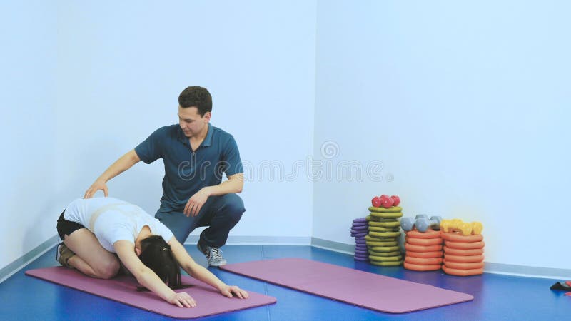 The Girl Doing the Restoring Exercis for Back in Rehabilitation Center ...