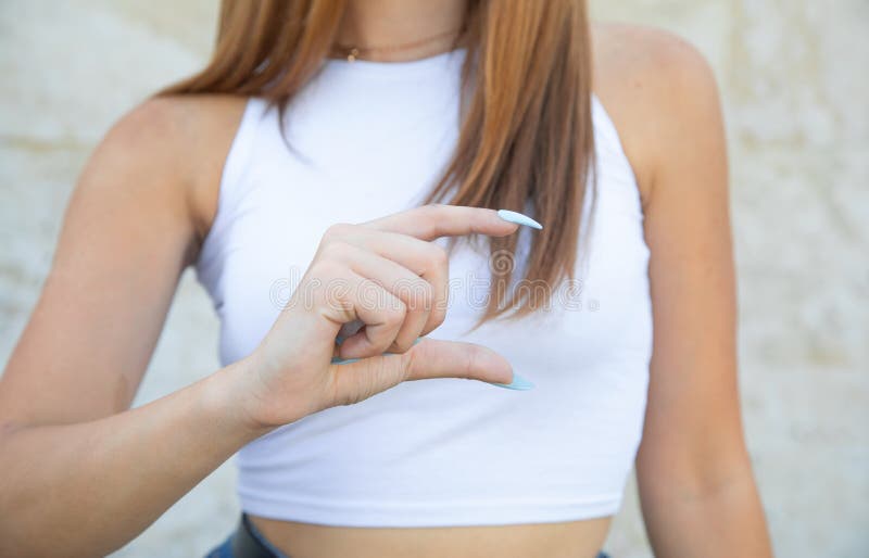 Girl Doing Small Size Sign with Fingers Stock Photo - Image of female ...