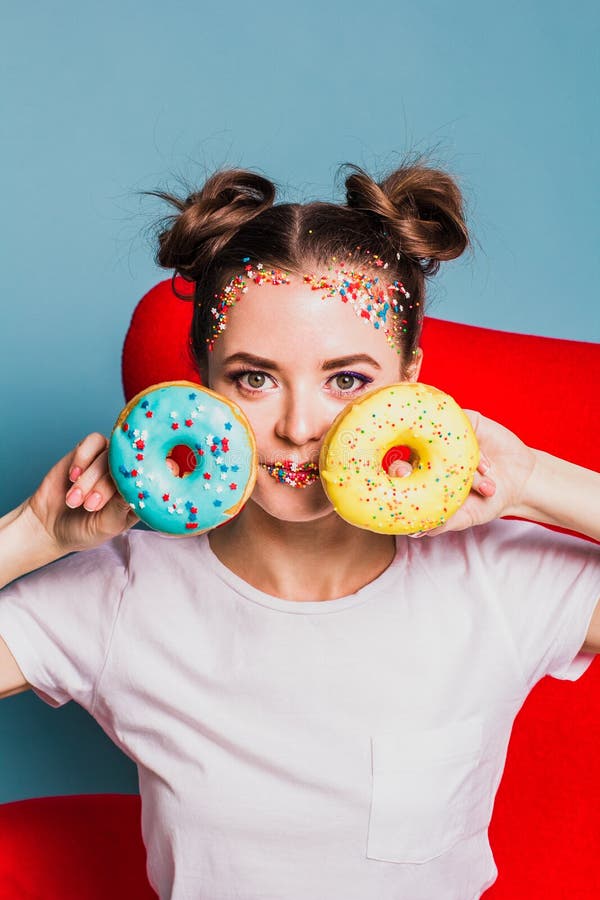 Girl with two donuts stock image. Image of colors, food - 75634047