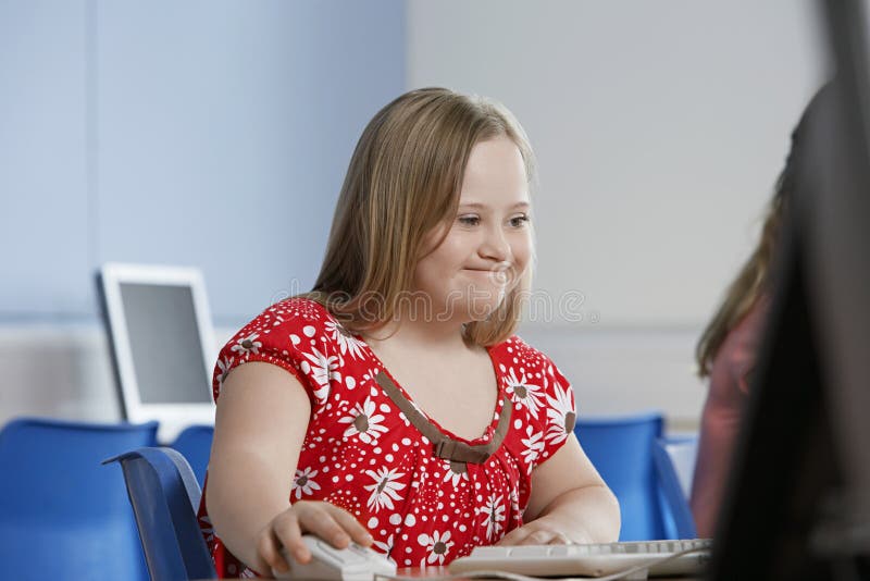 Girl (10-12) with Down Syndrome Using Computer in Computer Lab Stock ...