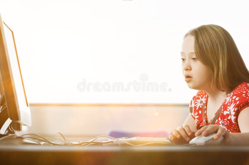 Girl with Down Syndrome Using Computer at School Stock Photo - Image of ...