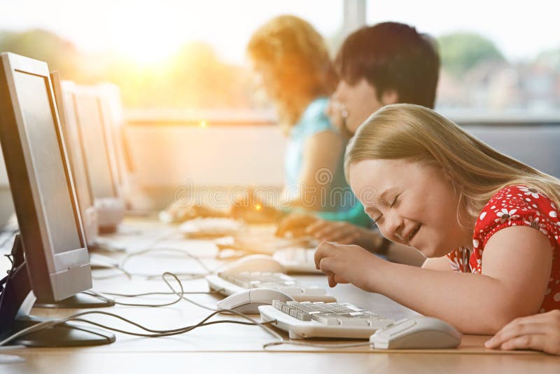 Girl with Down Syndrome Using Computer at School Stock Photo - Image of ...