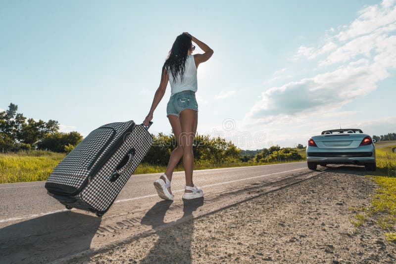 Beautiful Woman Hitchhiking By A Broken Car Girl Stands At His Car And
