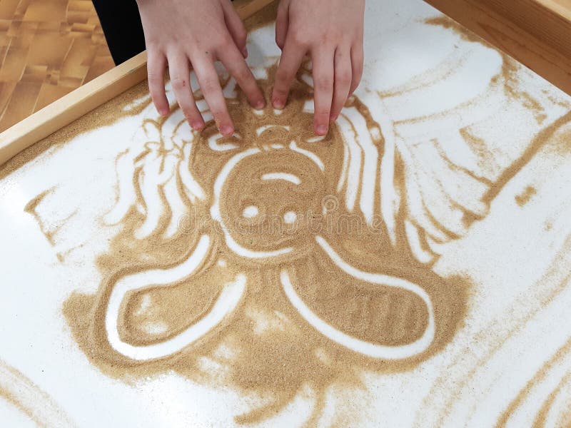 A Girl Draws a Bunny on a Light Table. Drawing Sand. Stock Photo ...