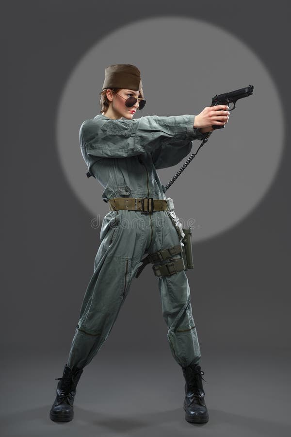 A Girl Dressed As a Helicopter Pilot with a Gun in His Hand. Stock ...