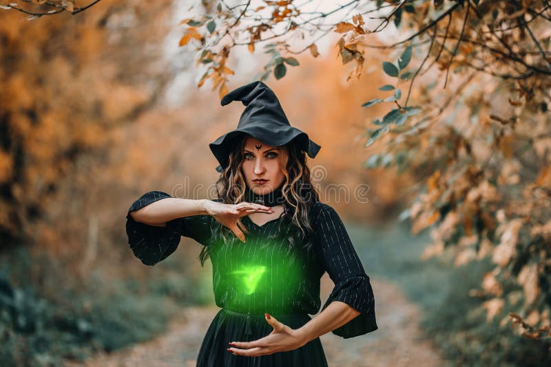 Girl Dressed As Witch Casts Spell in the Form of Green Triangle in ...