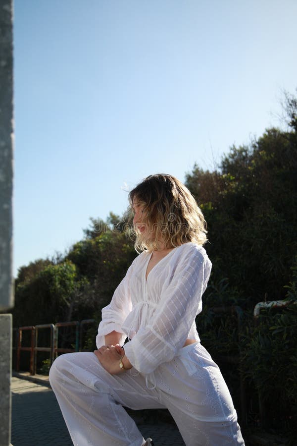 Girl Dressed in White Makes Dance Moves Holding on To the Railing Stock ...