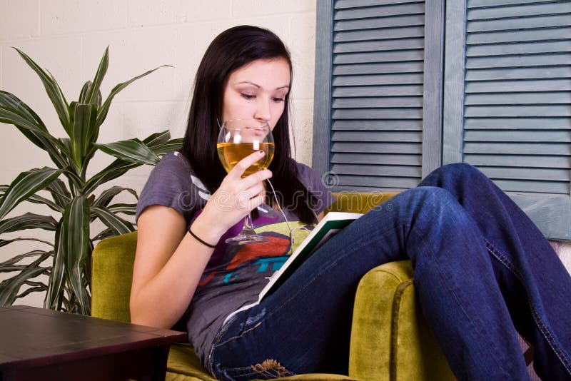 Girl Drinking while Reading a Book Stock Photo - Image of listening ...