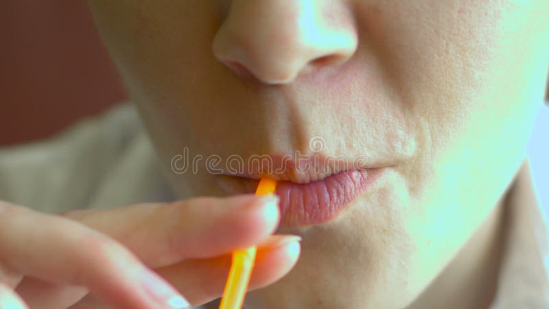 Girl Drinks A Milkshake Through A Straw While Sitting In A Cafe Stock