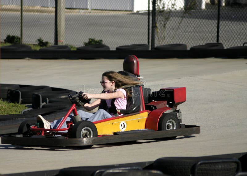 Girl driving go cart stock photo. Image of eyeglasses - 3551370
