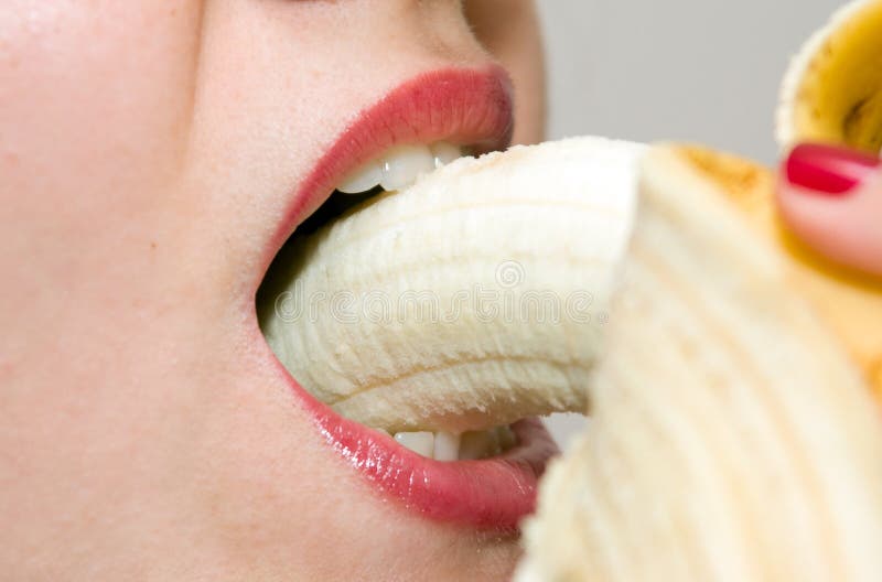 Girl eating banana closeup stock image. Image of white - 5275203
