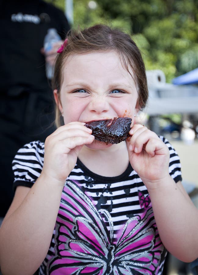 Girl eating bbq rib stock image. Image of meat, portrait - 26694659