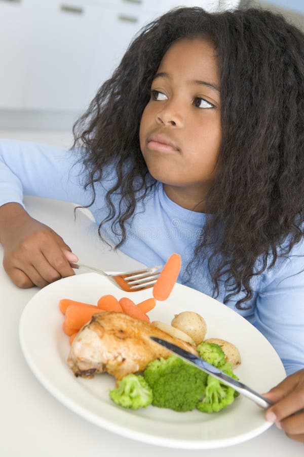 Young Girl in Kitchen Eating Chicken and Vegetable Stock Image - Image ...